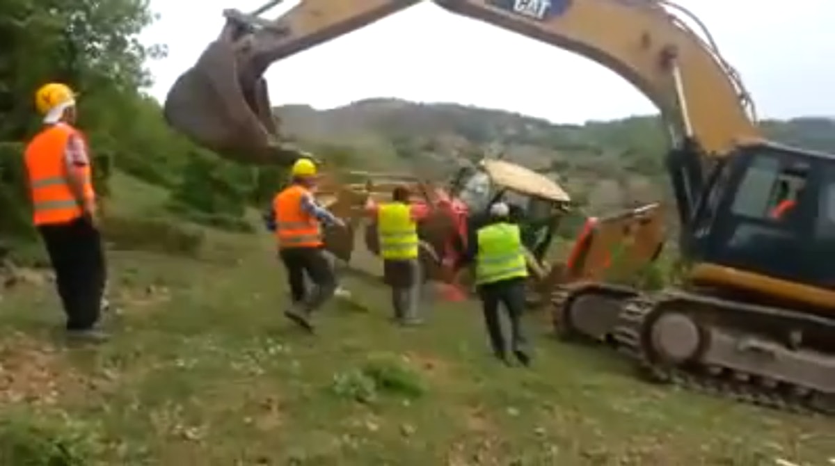 Excavator, crew upright a backhoe only to watch it roll down a steep ...