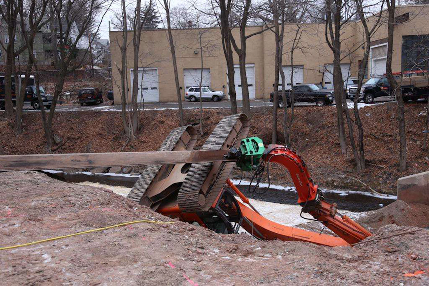 Excavator operator survives nasty rollover off of Connecticut bridge ...