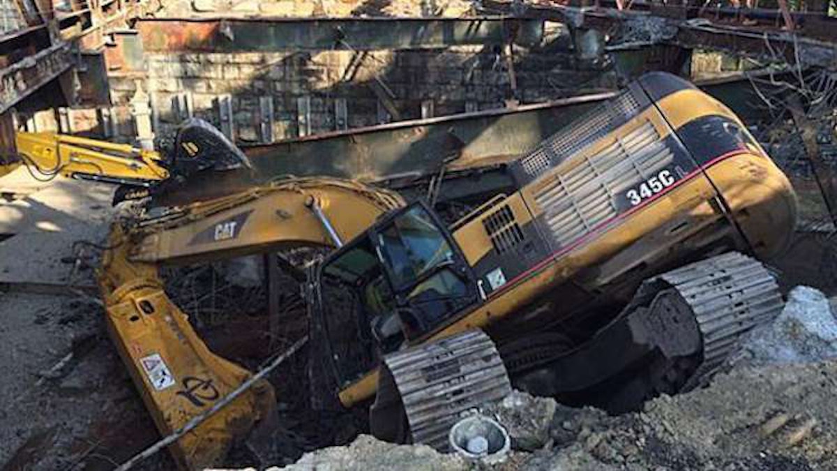 Excavator falls from bridge onto train tracks during demolition (PHOTOS ...